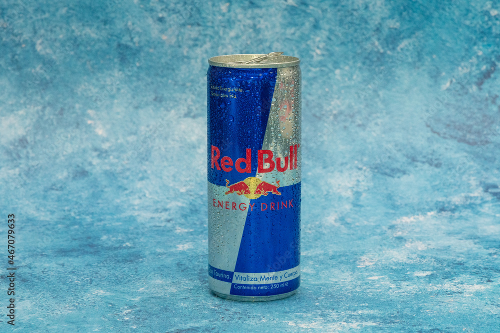 Aluminium can of Red Bull Energy drink with ice and drops. Red Bull is ...