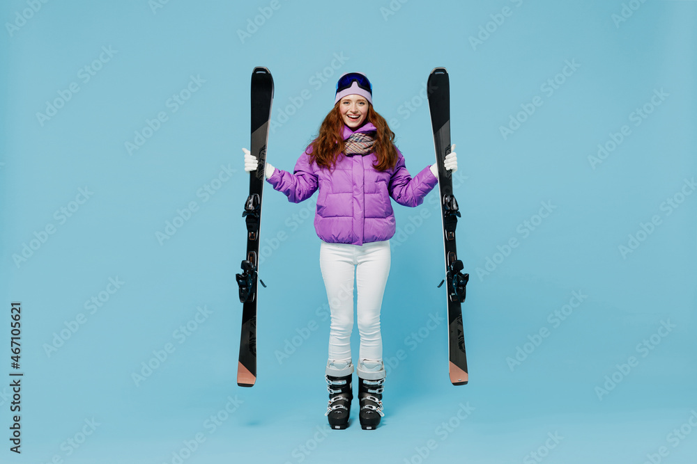 Full size skier smiling happy cheerful fun woman in warm purple padded ...