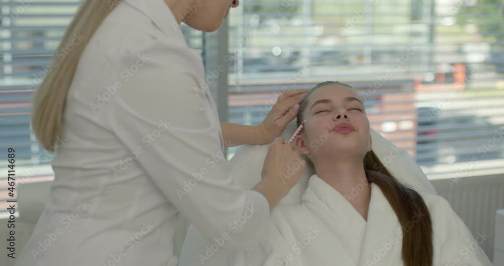 Injection at beauty salon. Pretty female patient came to get beauty ...