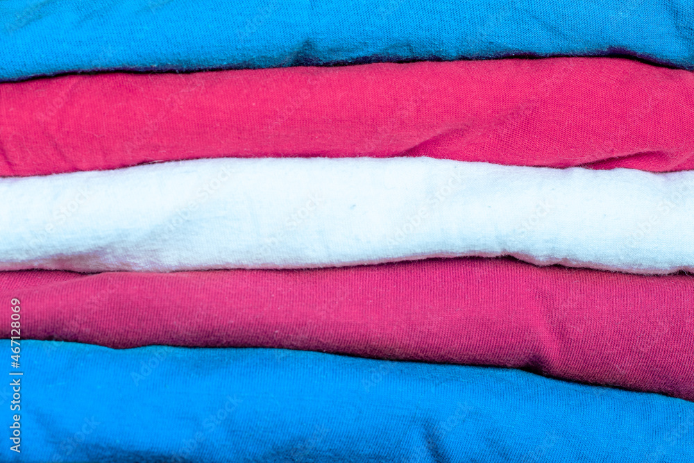 A stack of clothes folded in the colors of the transgender community ...