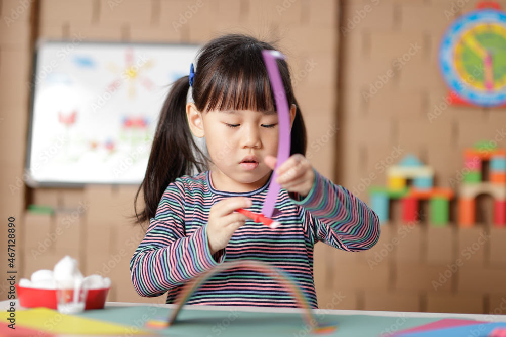 young girl making paper craft for homeschooling Stock Photo | Adobe Stock