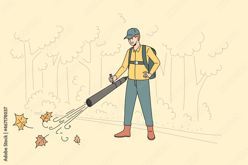 Cleaning park from fallen leaves concept. Young smiling man worker ...