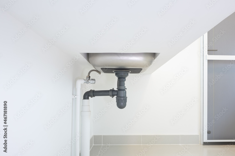 Drain pipe or sewer under kitchen sink. Pvc plastic pipe and flexible ...