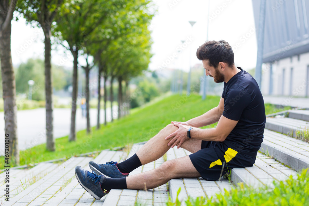 Athlete male injured during training, has severe leg pain, muscle aches ...