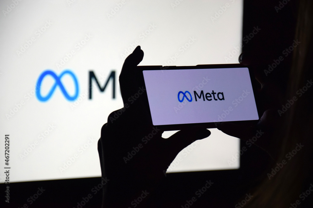 Smartphone with Meta logo on the background on logos of products owned ...