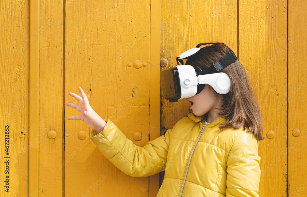 Girl in yellow jacket wearing VR headset Stock Photo | Adobe Stock