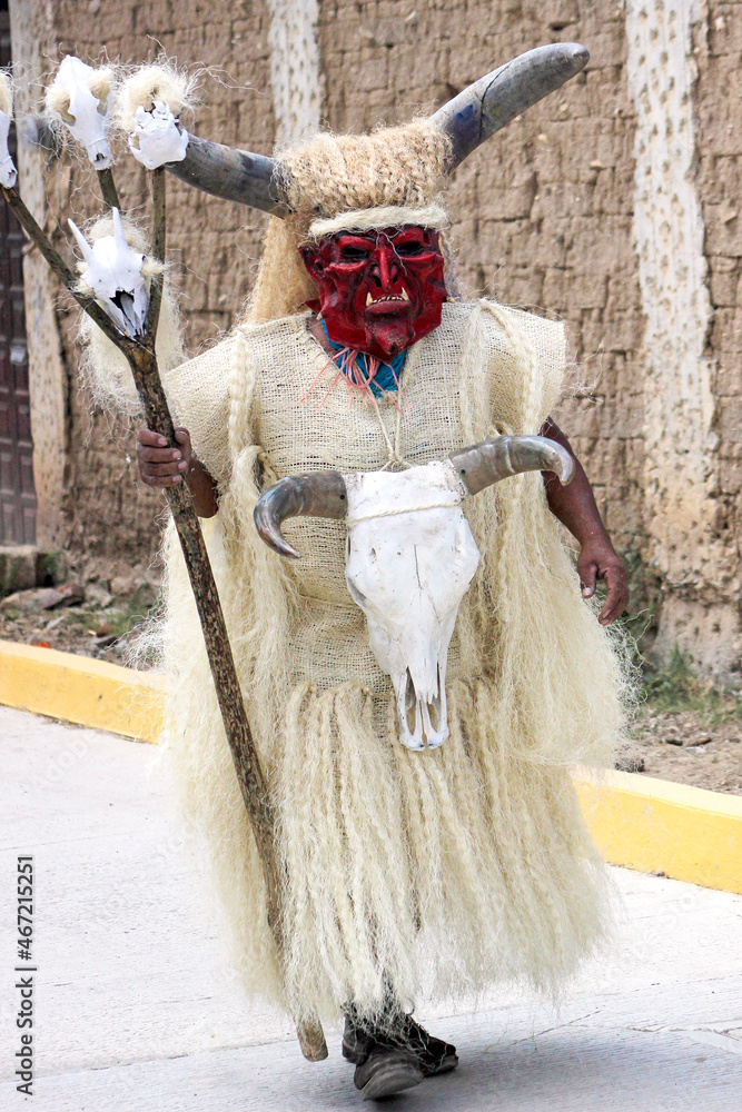 Man wearing devil's mask wearing light outfit Stock Photo | Adobe Stock