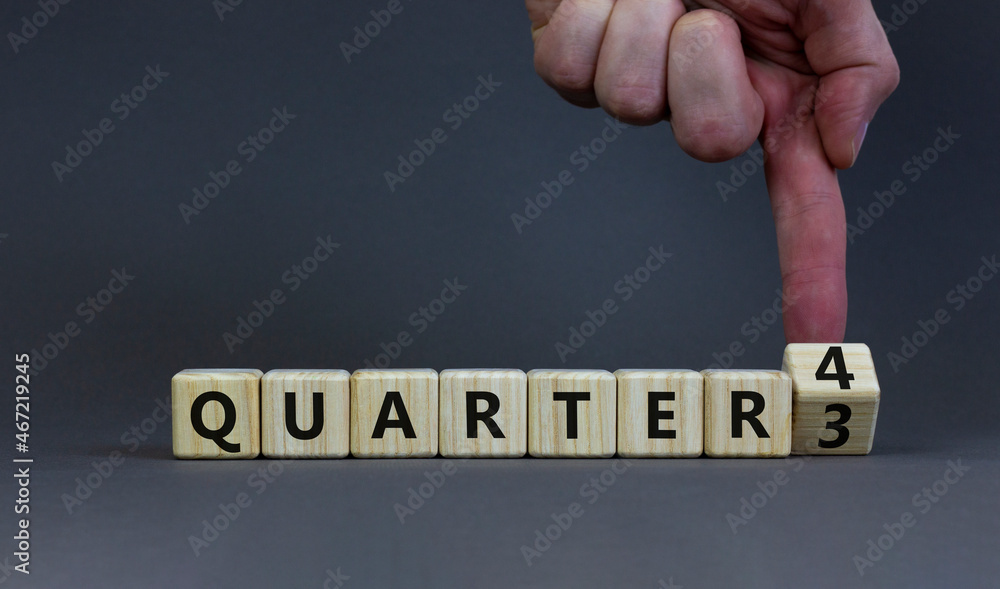 From 3rd to 4th quarter symbol. Businessman turns a cube and changes ...