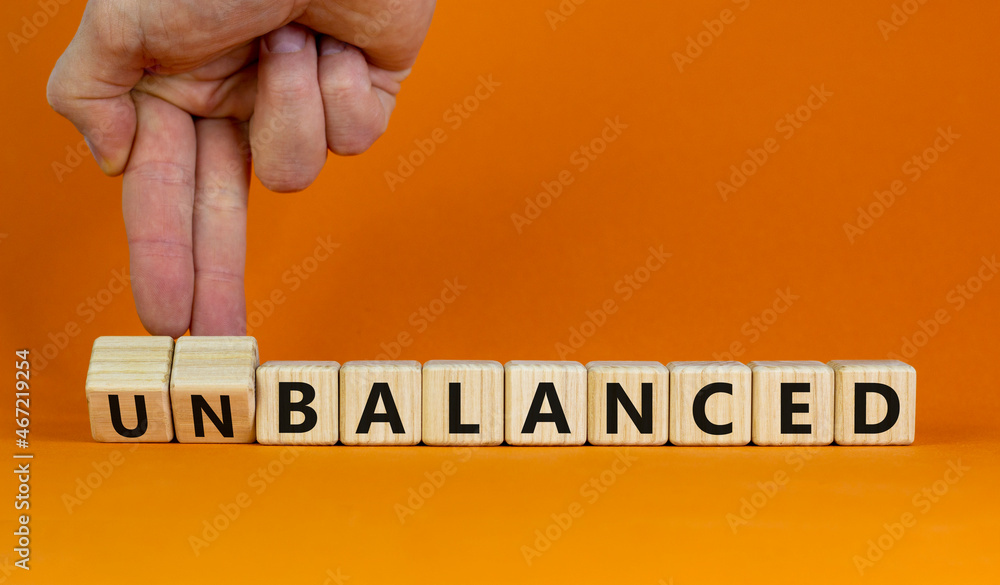 Balanced or unbalanced symbol. Businessman turns cubes, changes words ...
