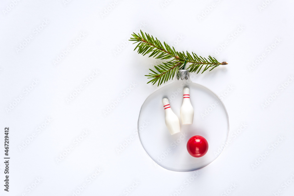 Christmas tree toy made of red bowling ball and pins on white ...