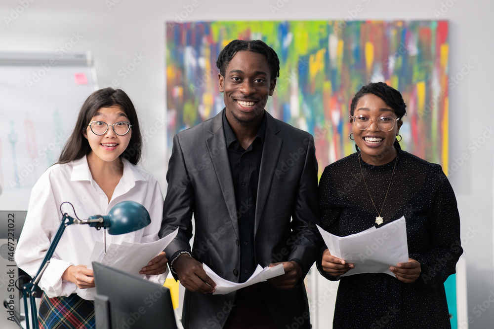 Ambitious smiling company employees of different nationalities, dressed ...