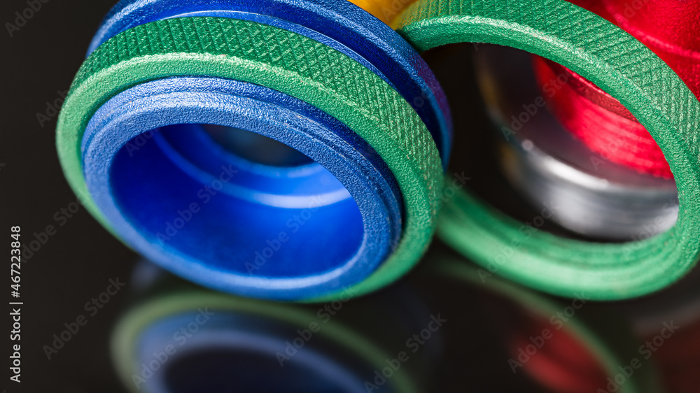 Green knurled nuts and colored router guide bushings detail on black ...