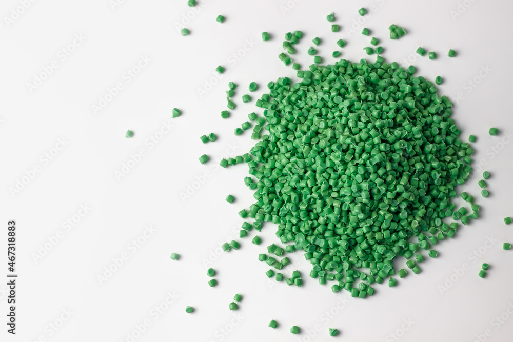 green granules of polypropylene or polyamide on a white background ...