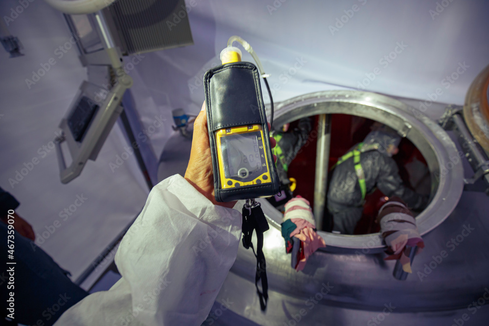 Worker hand holding gas detector inspection safety gas testing at front ...