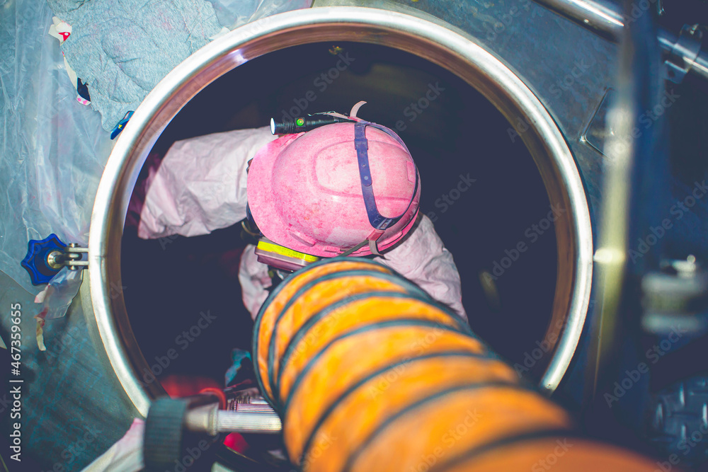 Top view male climb up the stairs into the tank stainless chemical ...