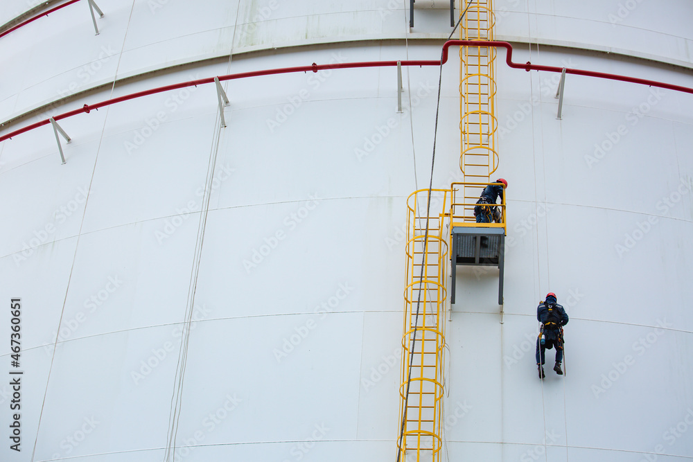 Male two workers down height ladder tank rope access inspection of ...