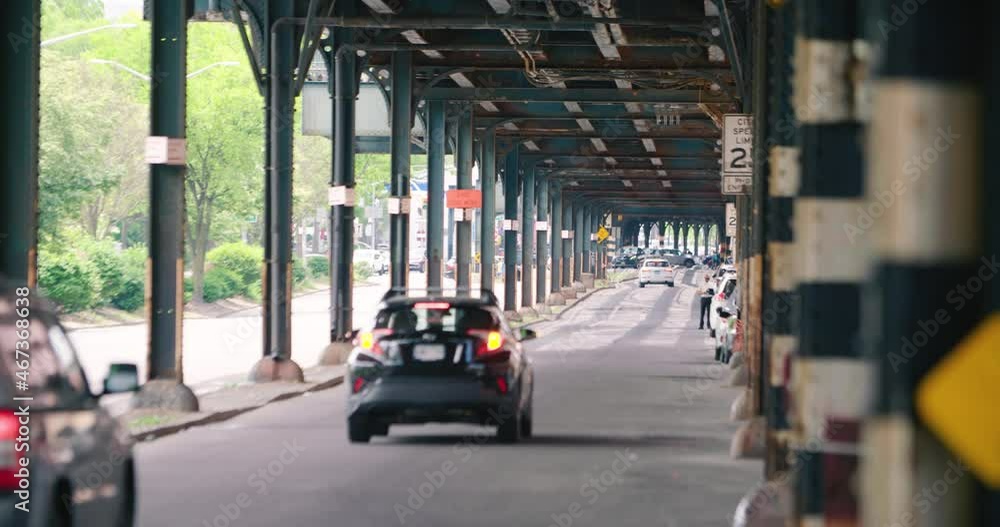 A 4K of the cars driving under elevated train tracks in the Bronx Stock ...