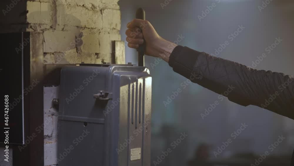 The handle generator switch at an industrial plant. A man's hand turns ...