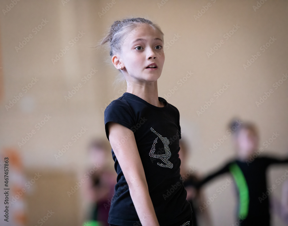 Portrait of girl gymnast who is running and going to jump in gym on ...