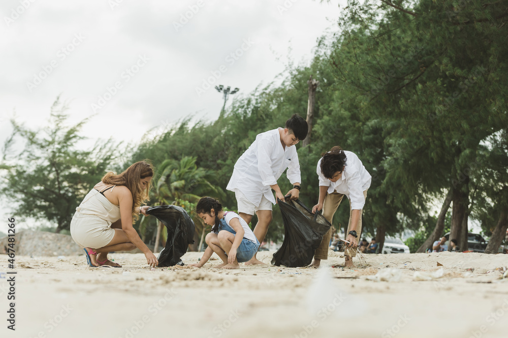 Asian family collecting plastic waste on the beach. young people ...