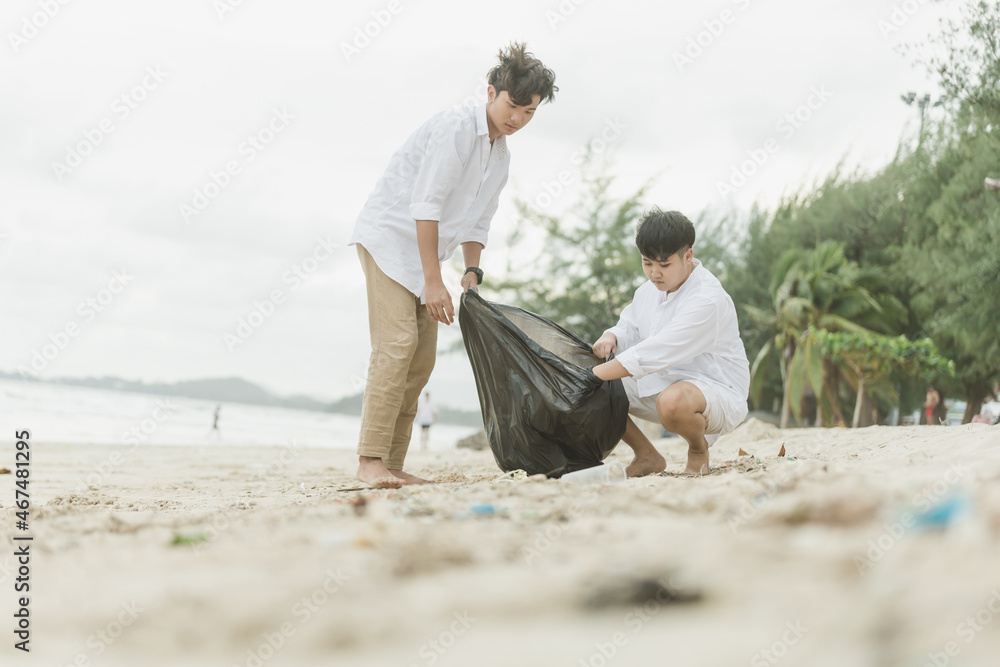 Asian family collecting plastic waste on the beach. young people ...