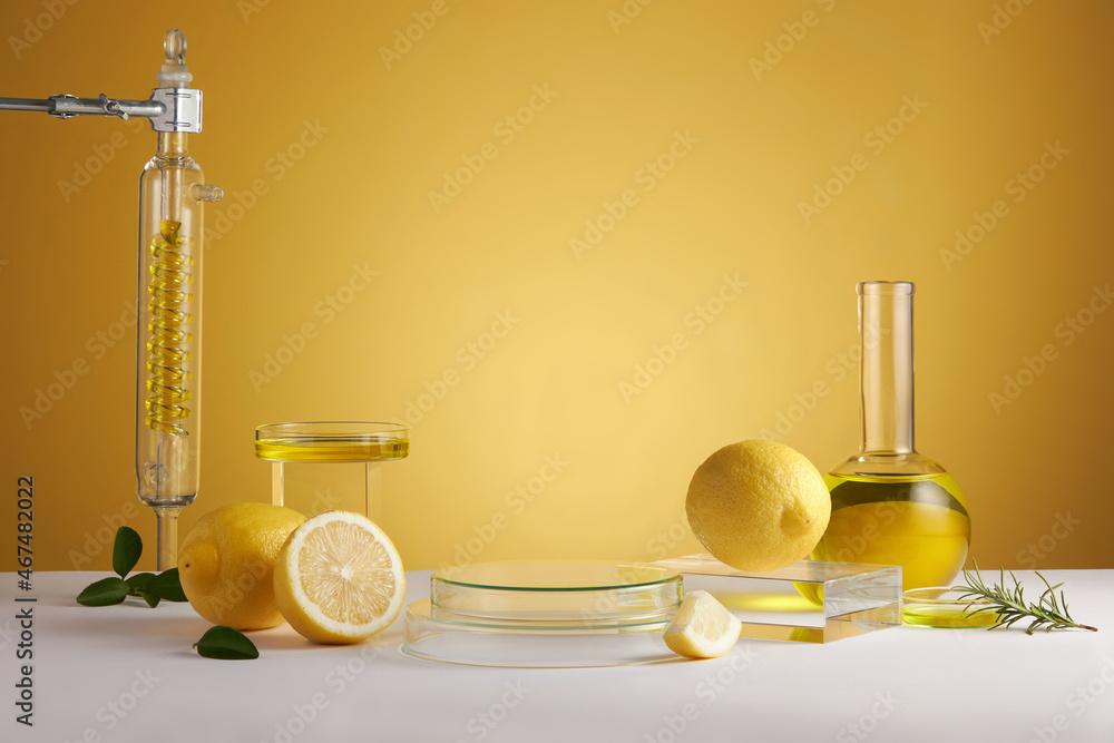 Lemon extract in test tube petri dish and lemon and sliced lemon ...