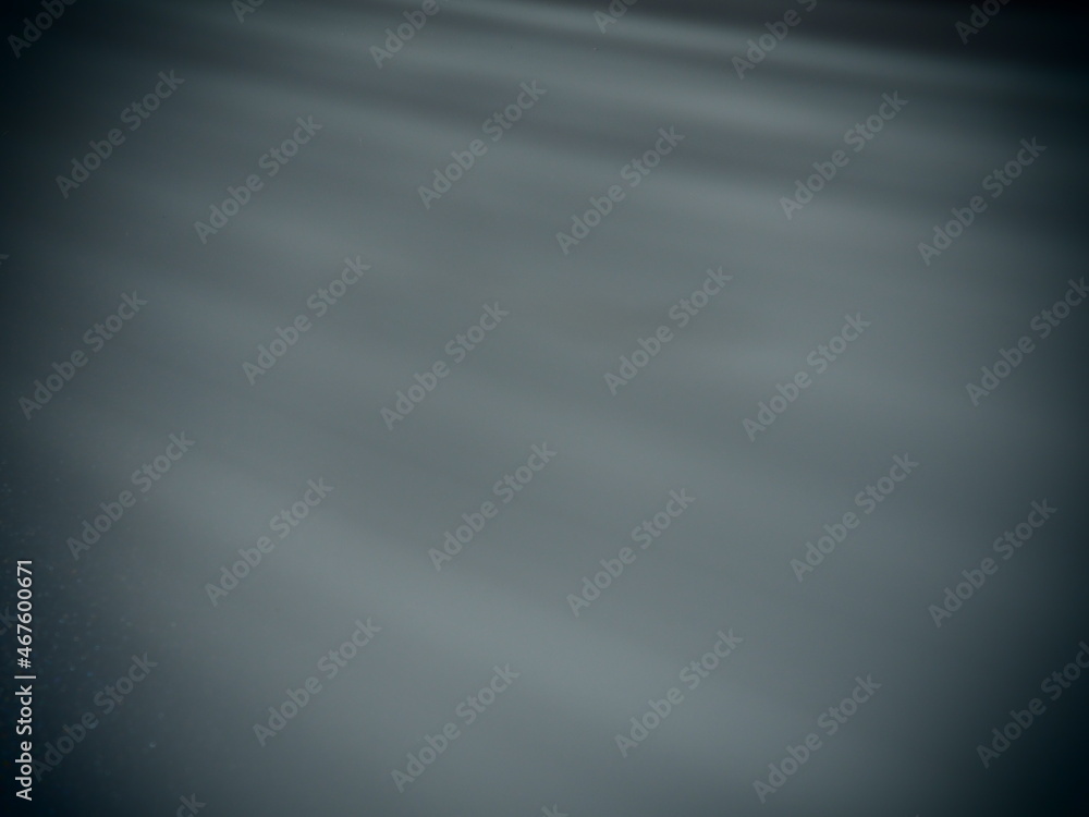 Diagonal rays of light on a gray background. Blurred abstract ...