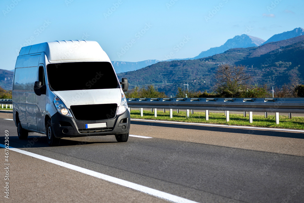 White modern delivery small shipment cargo courier van moving fast on ...