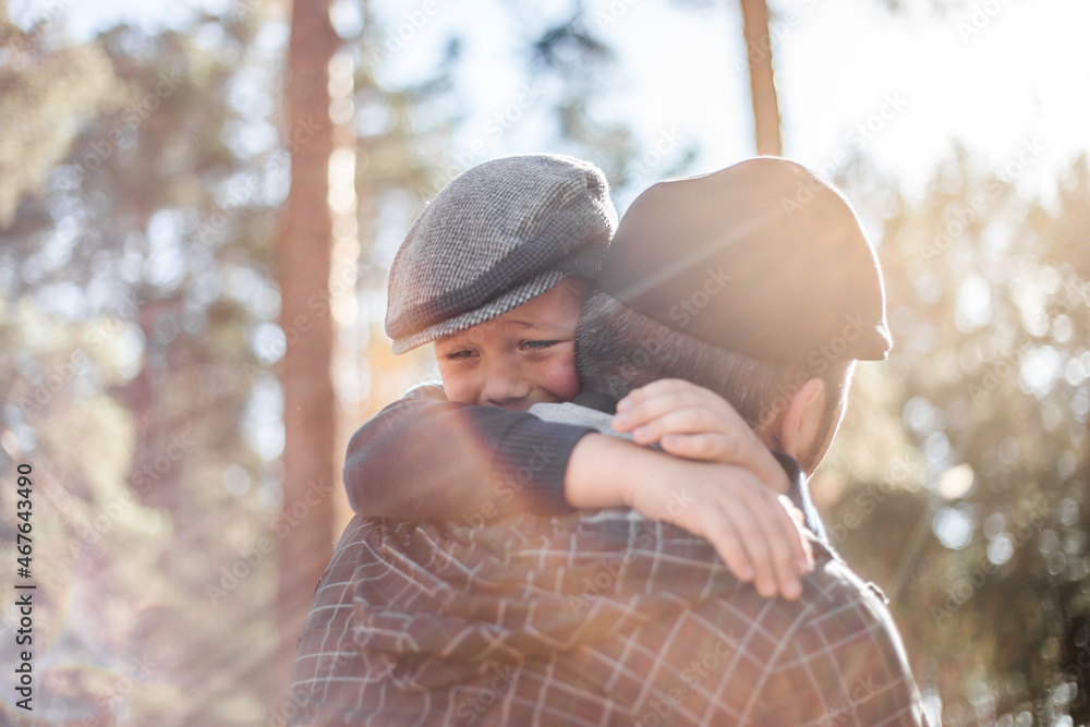 Father`s day. Sad son hugging dad on the forest background with copy ...