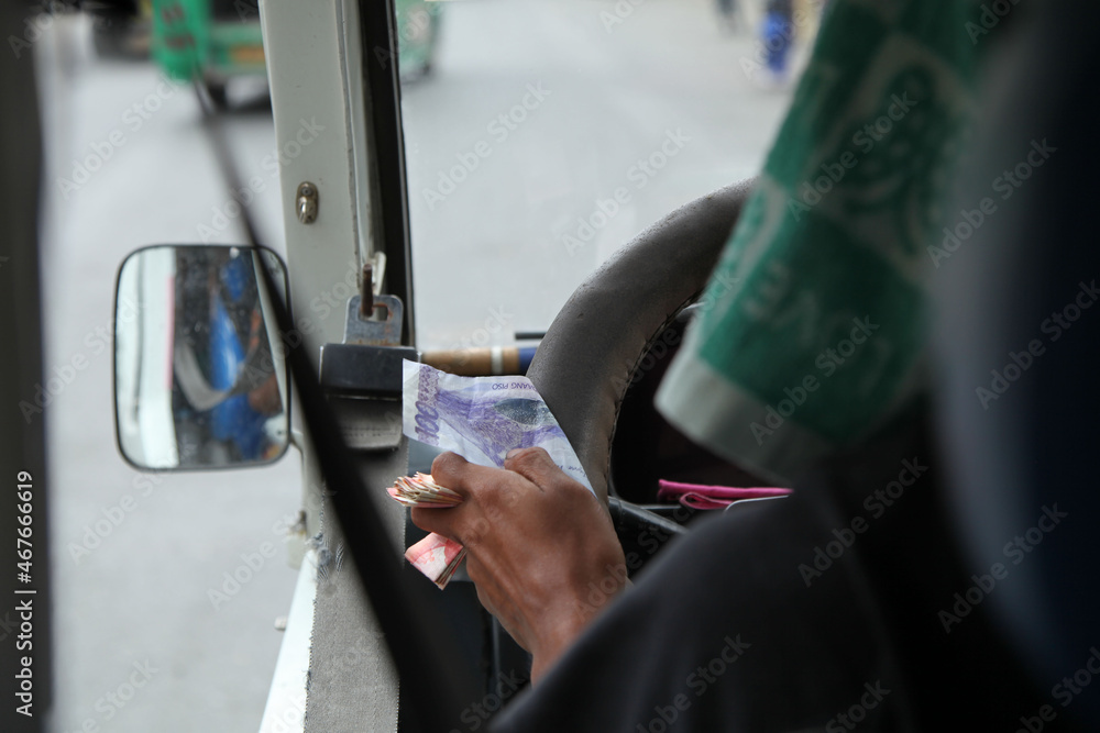 Jeepney taxi driver holding cash in his fingers, Davao, the Philippines ...