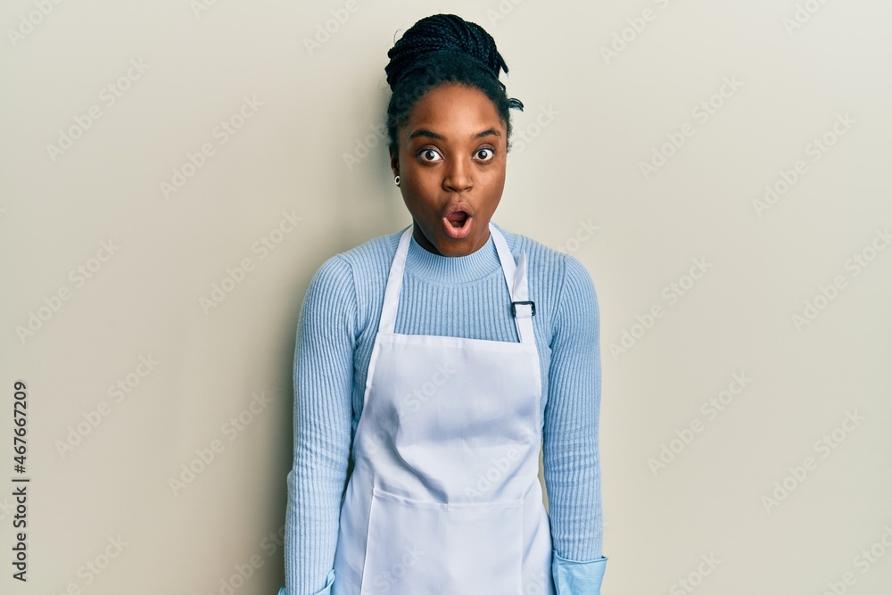 African american woman with braided hair wearing cleaner apron and ...