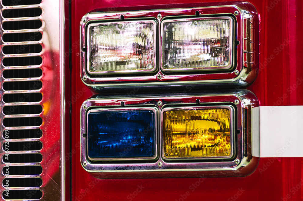 Fire truck headlights. Yellow and blue headlights of a fire truck ...