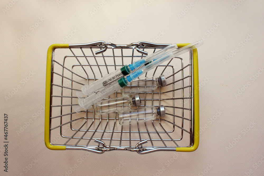 Basket with ampoules of medicines for injection, syringe. vaccination ...