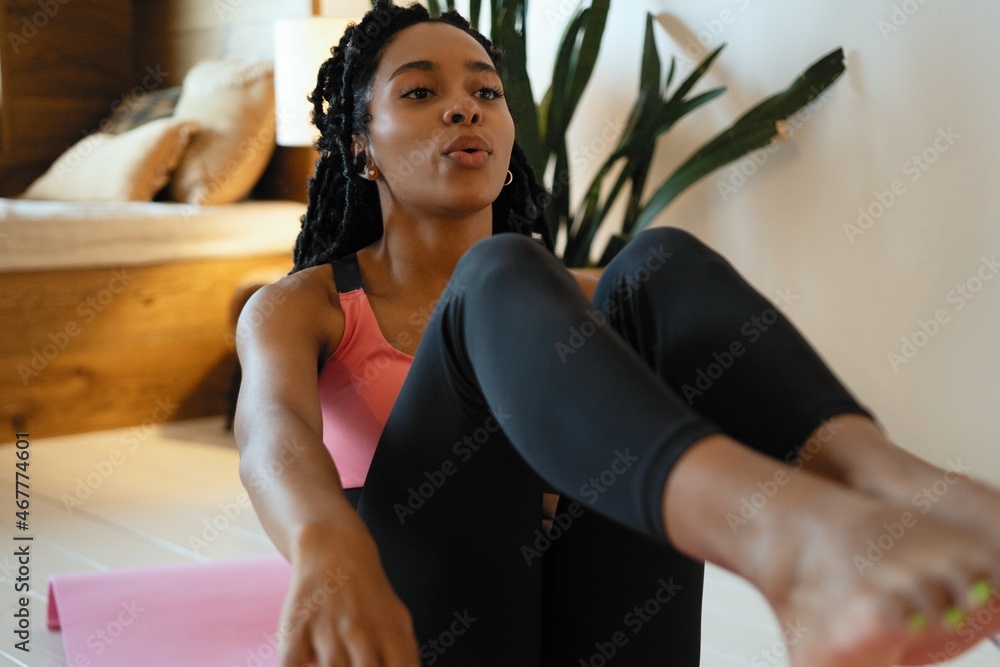 Attractive female doing exercise in her living room. She doing abs ...
