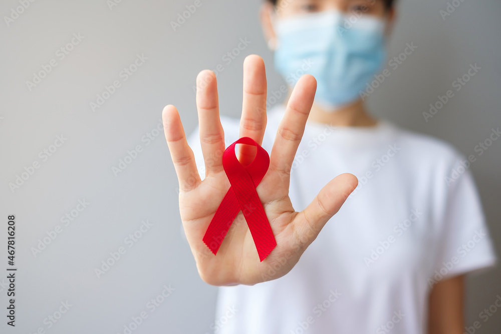 Hand holding Red Ribbon for December World Aids Day (acquired immune ...