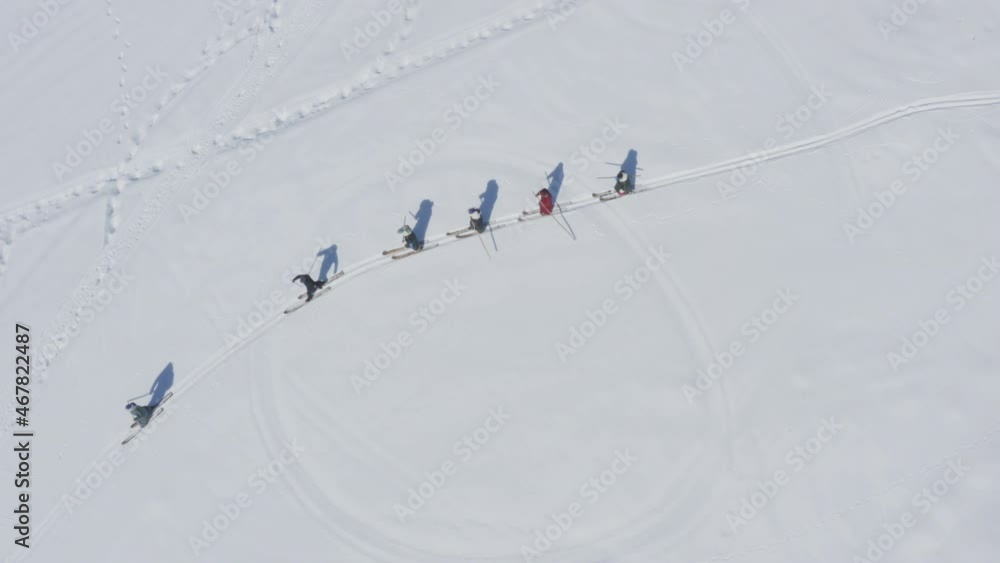 Tuva men in traditional clothing and fur skis walking in snow. Hemu ...
