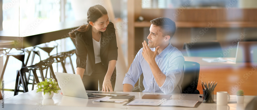 Female business consultant giving business advice to the office's male ...