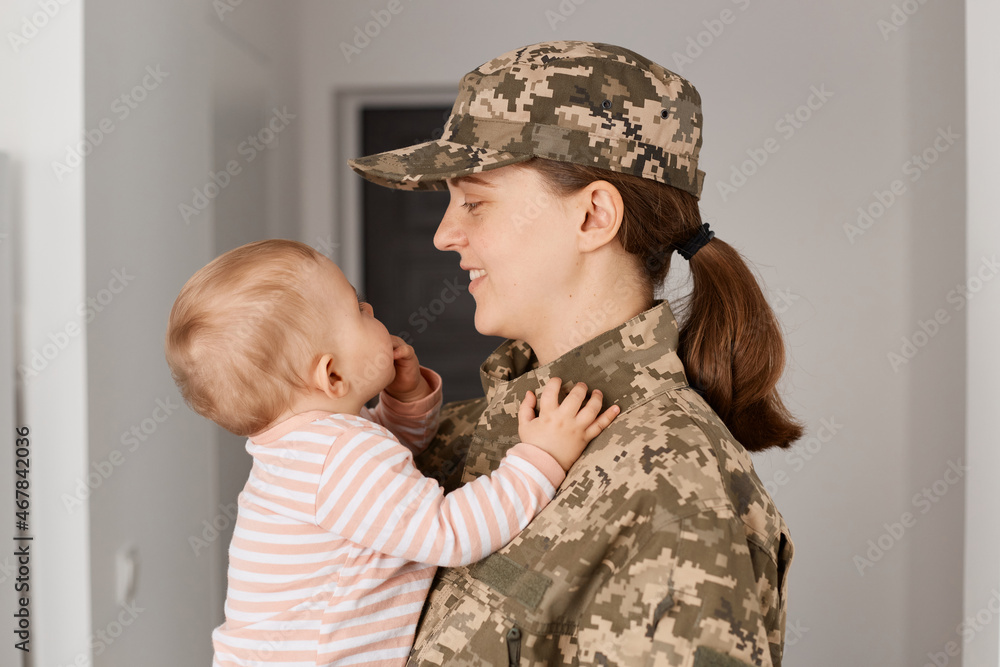 Side view portrait of smiling military mother wearing camouflage ...