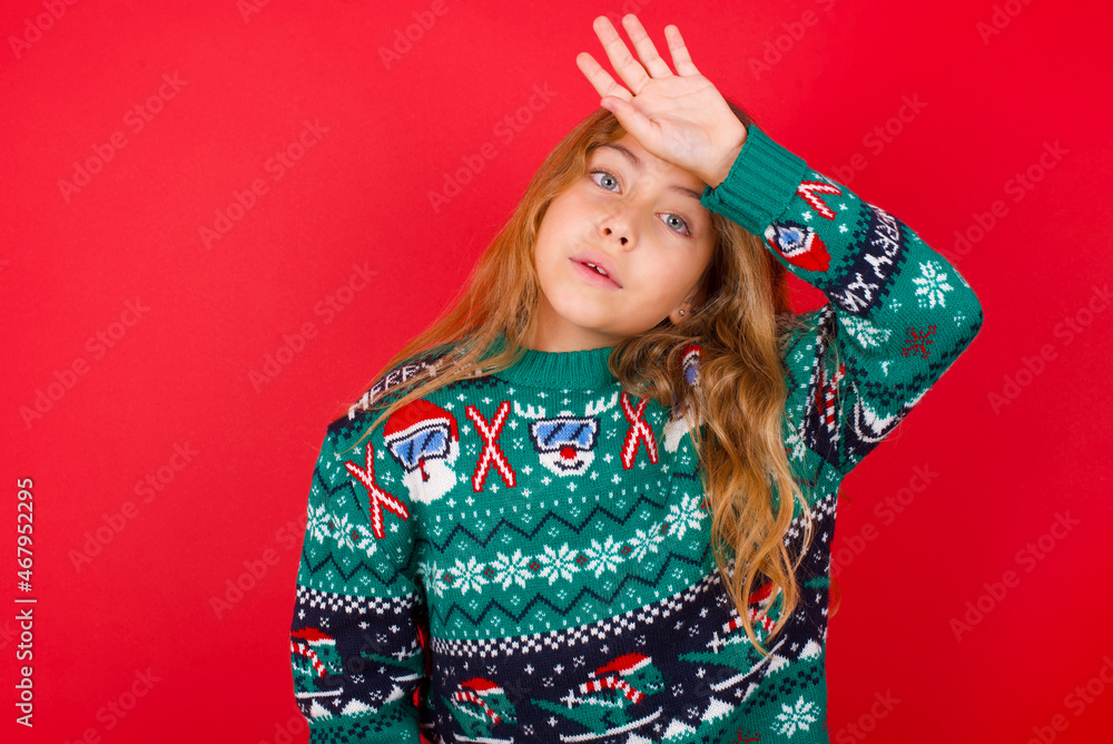 brunette kid girl in knitted sweater Christmas over red background ...