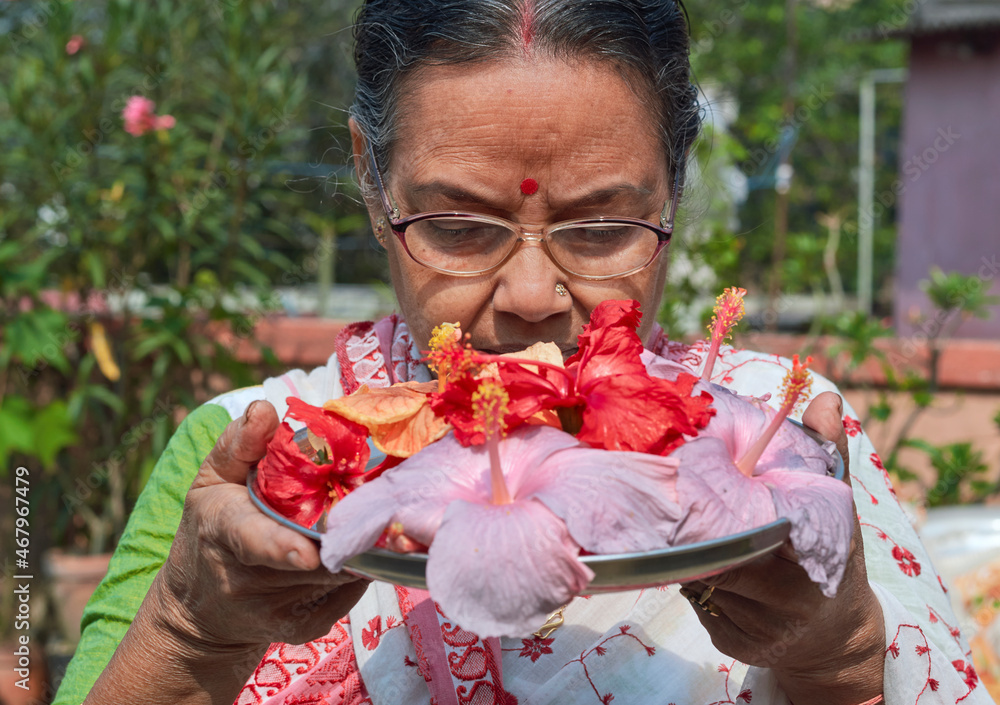 A simple looking, aged Bengali woman dressed in traditional sari ...