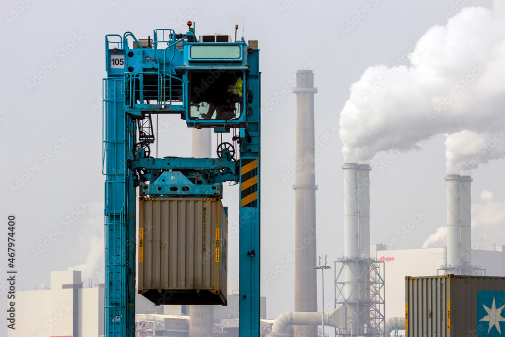 Straddle carrier moving a Maersk container in the shipping terminal of ...