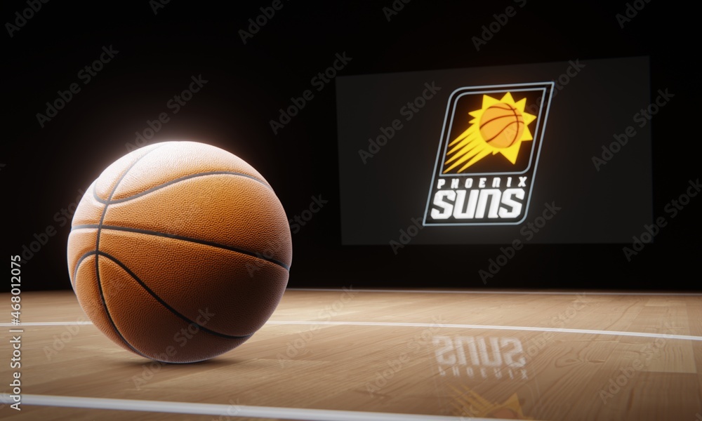 Basketball in foreground with logo of NBA team Phoenix Suns projected ...