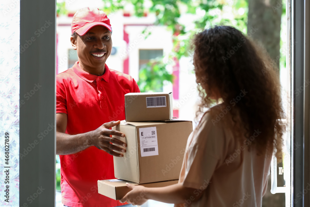 Customer receiving parcel from delivery man Stock Photo | Adobe Stock