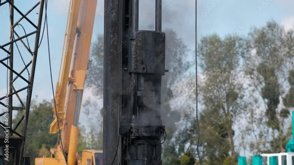Pile-driving (copra) part of the excavator in close-up. Pile driving ...