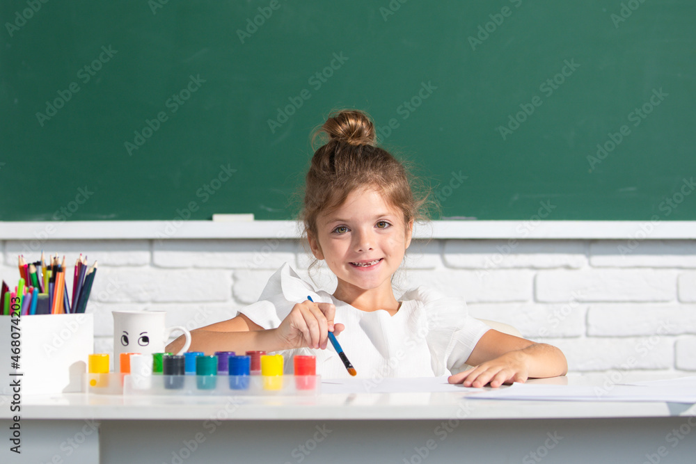 Painting school lesson, drawing art. Child girl draws in classroom ...