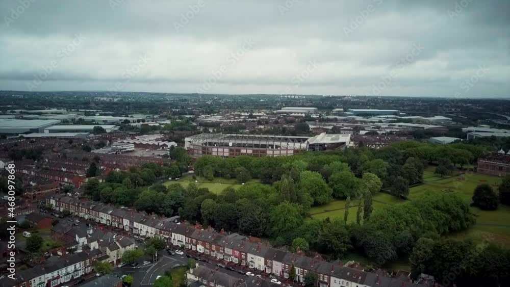 Arial shot tracking right to left over red brick terraced house looking ...