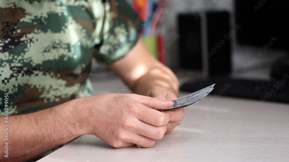 Hands counting US Dollar bills or paying in cash on money background ...