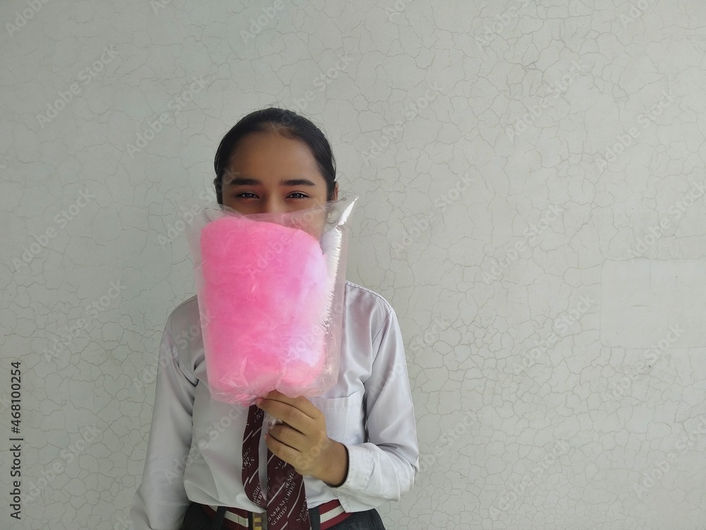 School ragging concept with a school student hiding her face with a ...