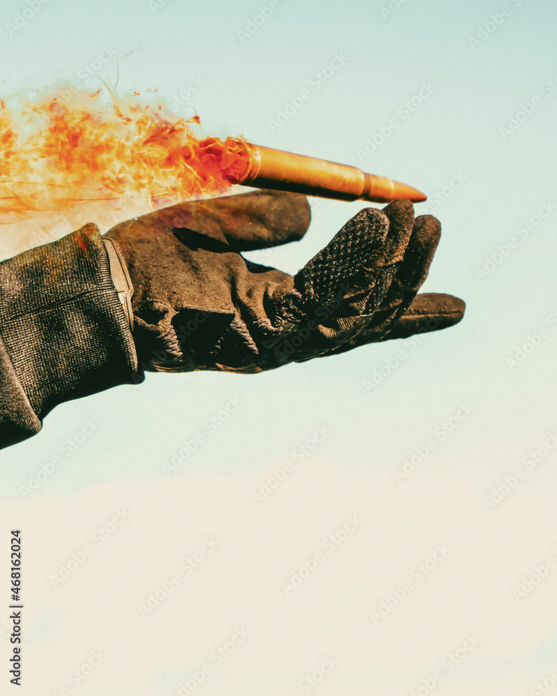 Exploding bullet. The man fires the bullet in his hand. Photo ...