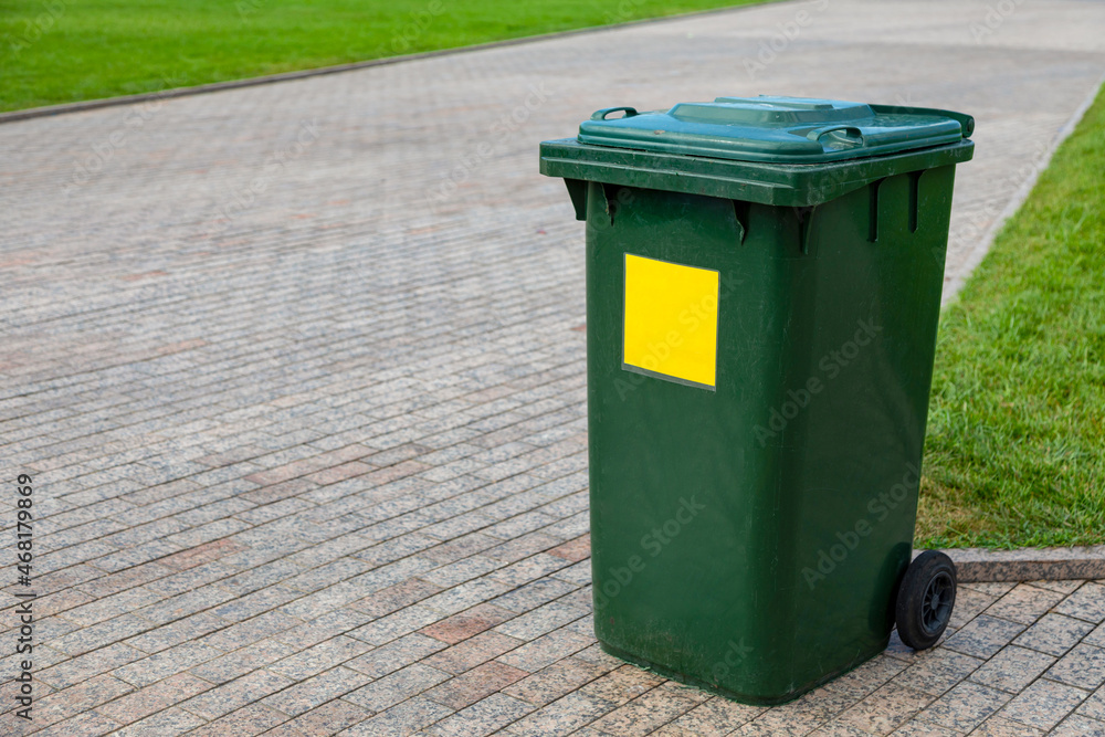 Plastic green garbage can for collecting garbage in the park. Mobile ...